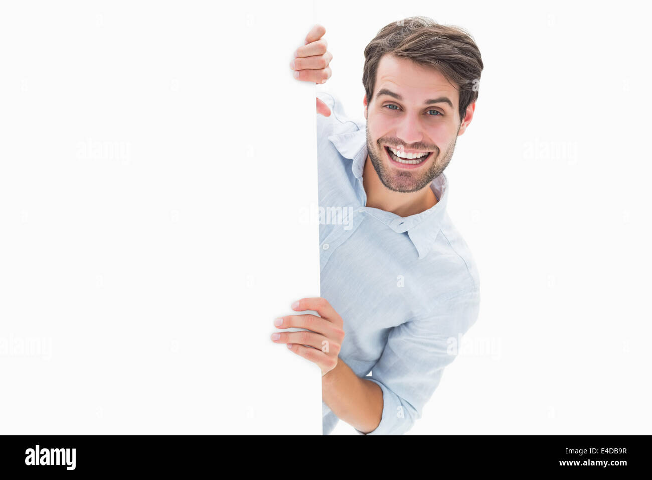 Attractive young man smiling and holding poster Stock Photo - Alamy