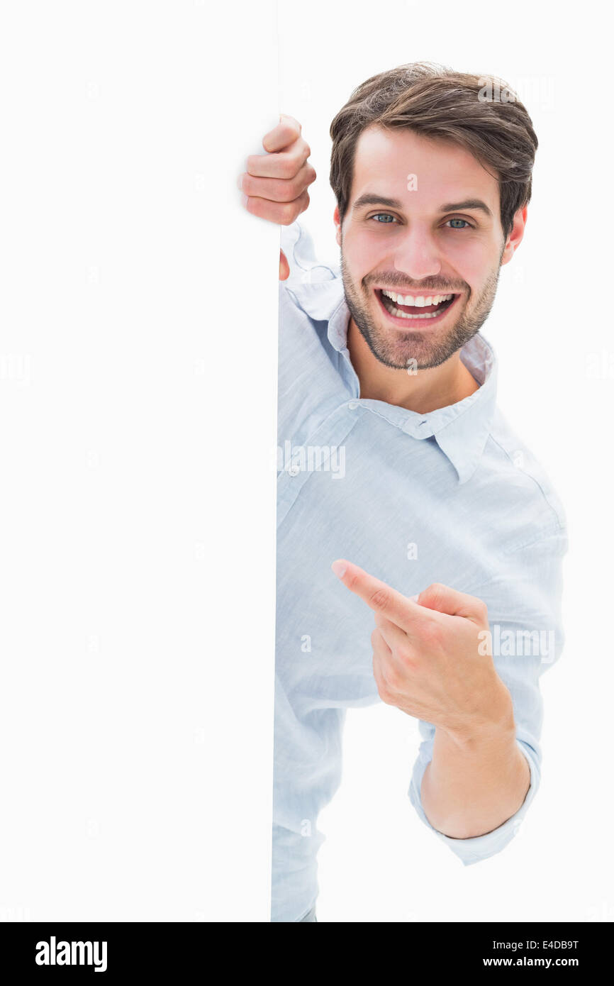 Attractive young man smiling and holding poster Stock Photo - Alamy