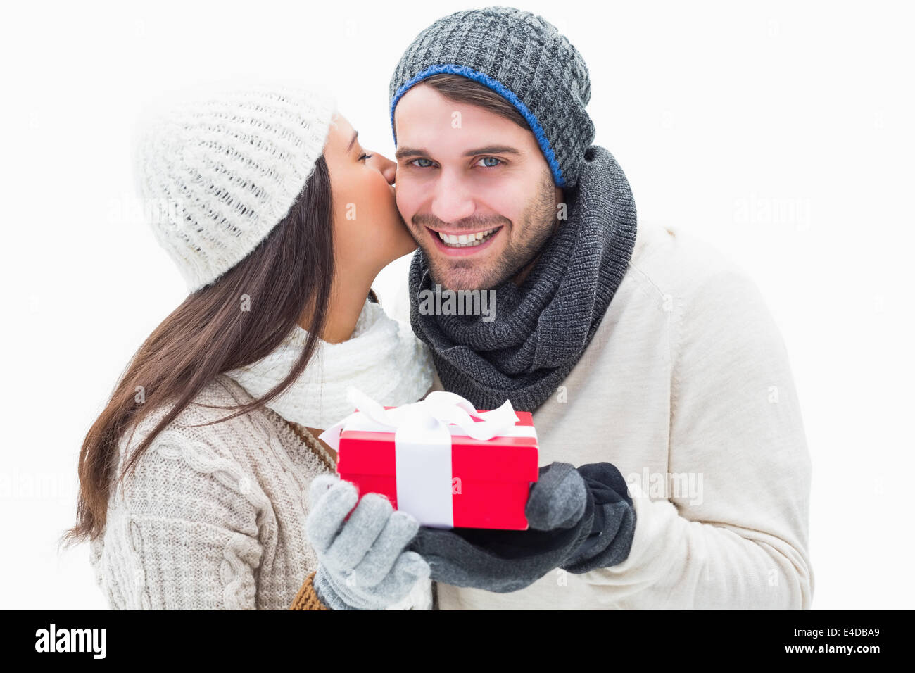 Attractive young couple in warm clothes holding gift Stock Photo - Alamy