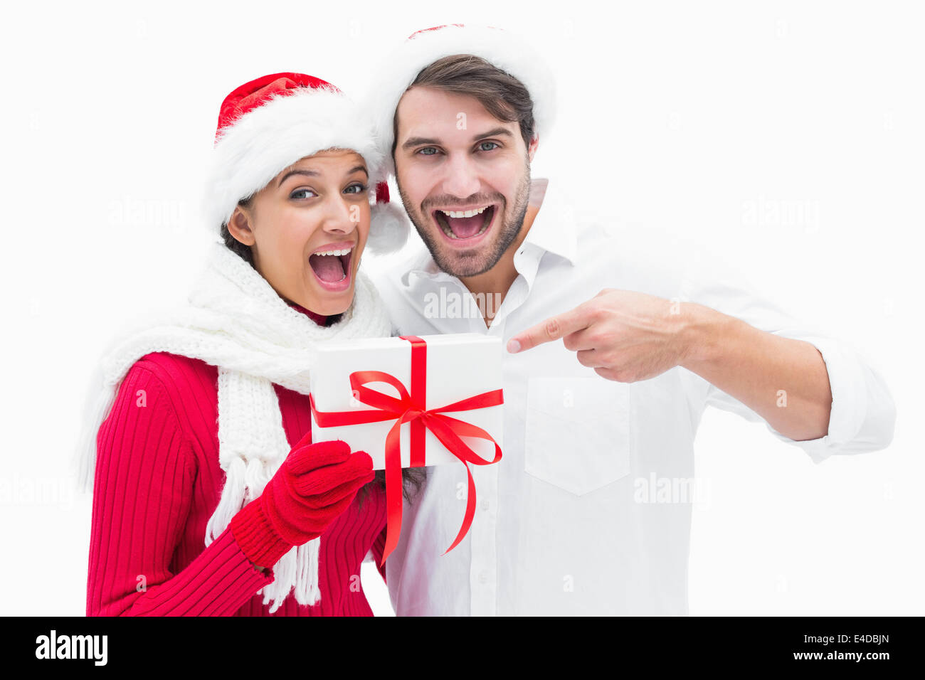 Attractive festive couple pointing to present Stock Photo - Alamy