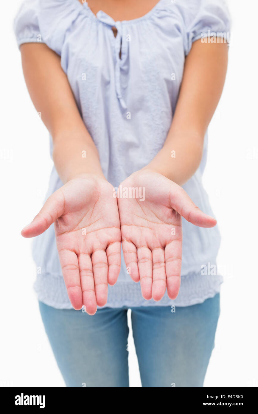 Casual young woman holding hands out Stock Photo - Alamy