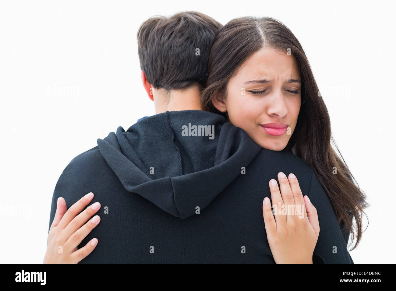 Unhappy brunette hugging her boyfriend Stock Photo - Alamy