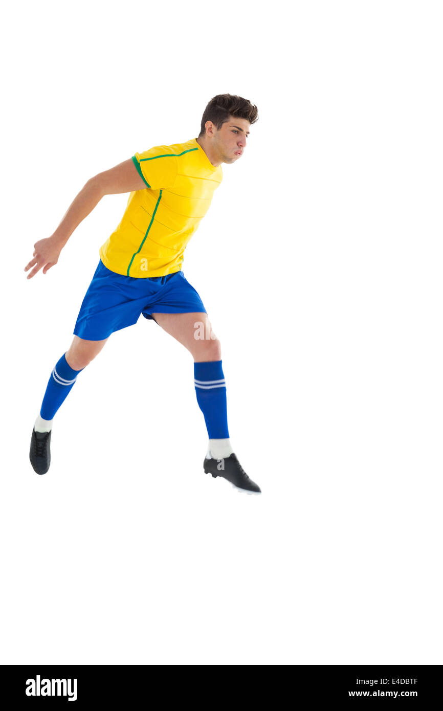 Football player in yellow jumping Stock Photo - Alamy