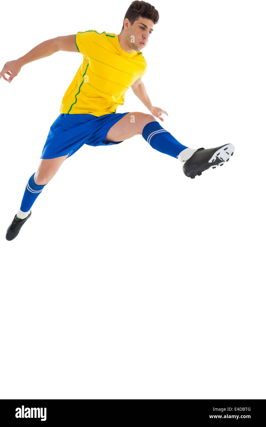 Football player in yellow jumping Stock Photo - Alamy