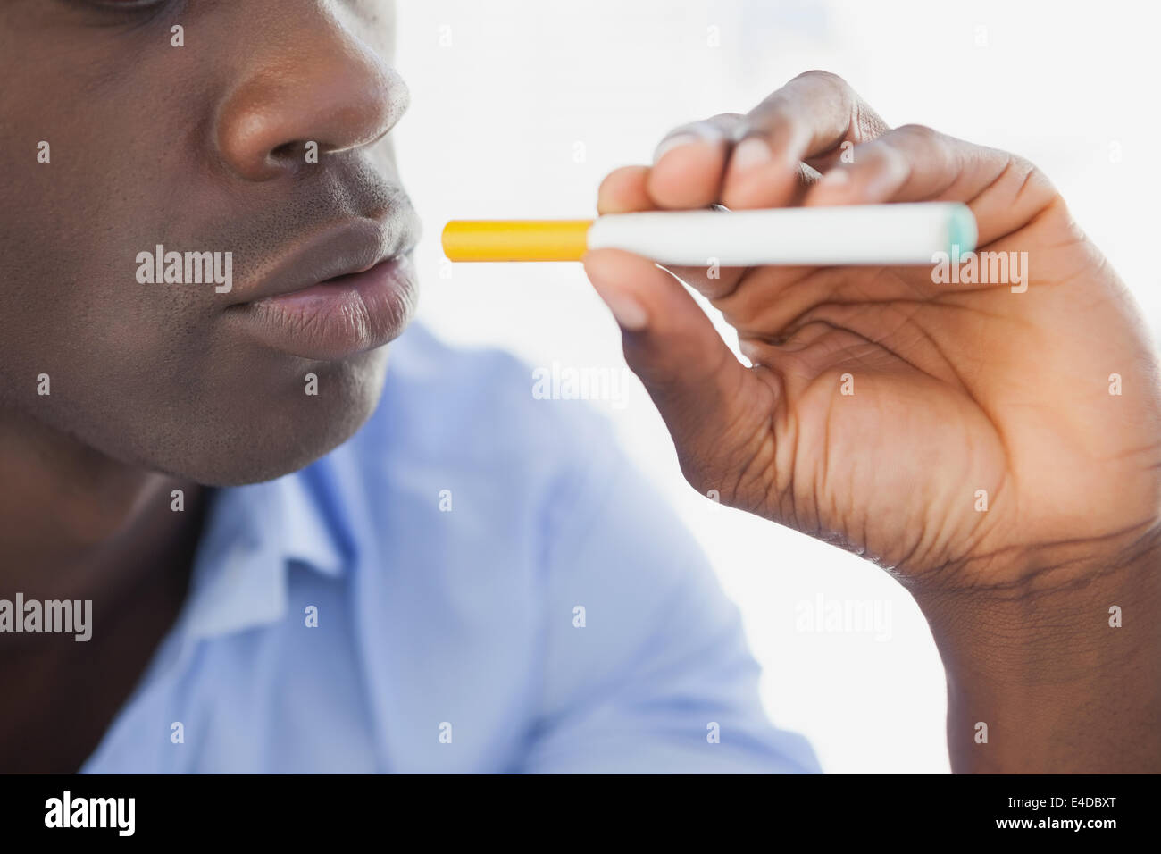 Businessman smoking an electronic cigarette Stock Photo - Alamy