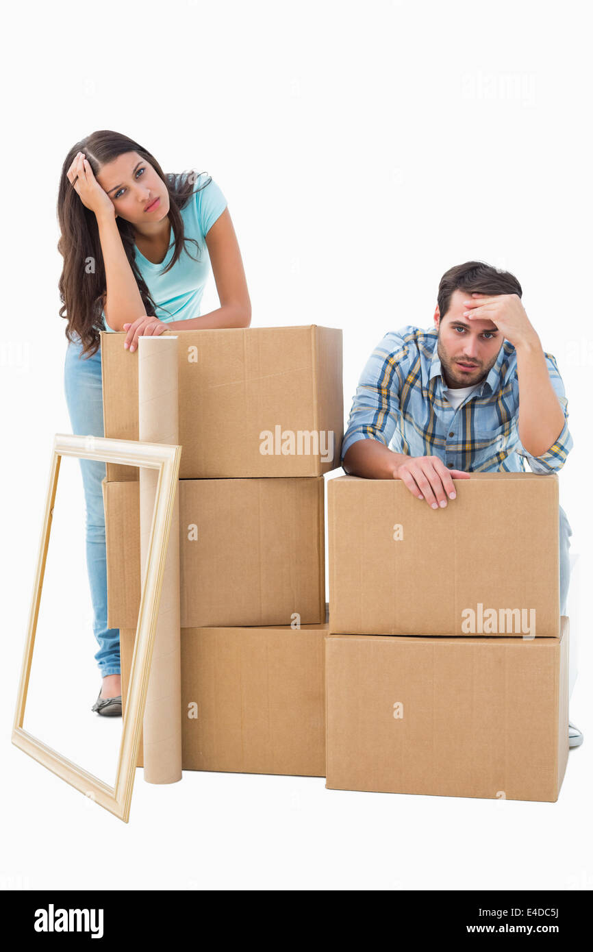 Stressed young couple with moving boxes Stock Photo - Alamy