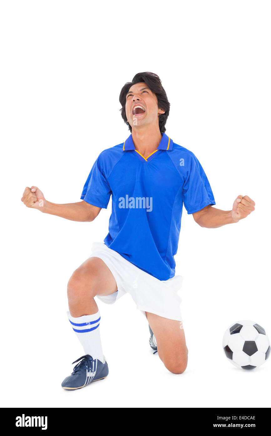 Football player in blue celebrating Stock Photo - Alamy