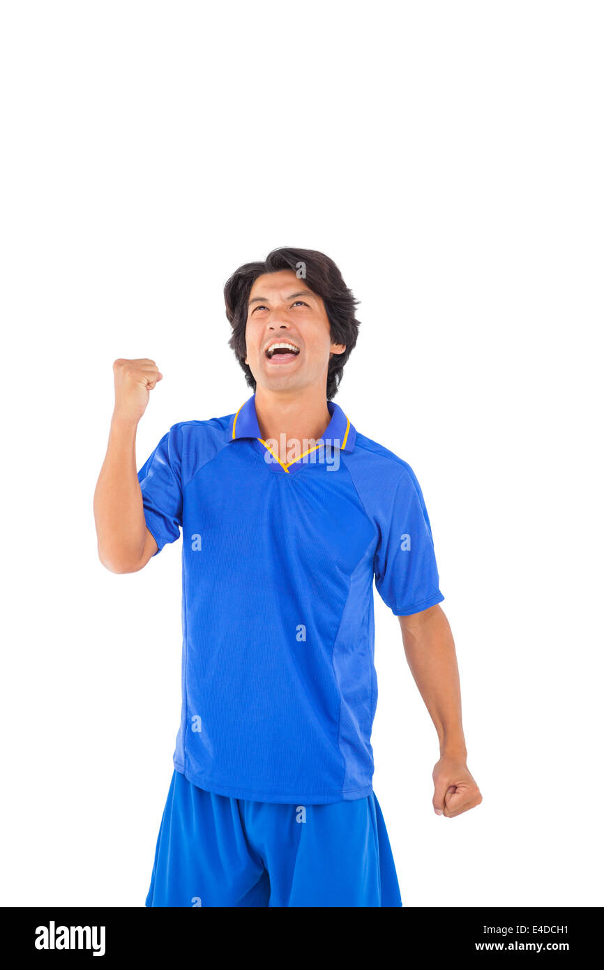 Football player in blue celebrating a victory Stock Photo - Alamy