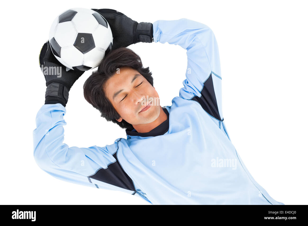 Goalkeeper in blue holding ball Stock Photo - Alamy