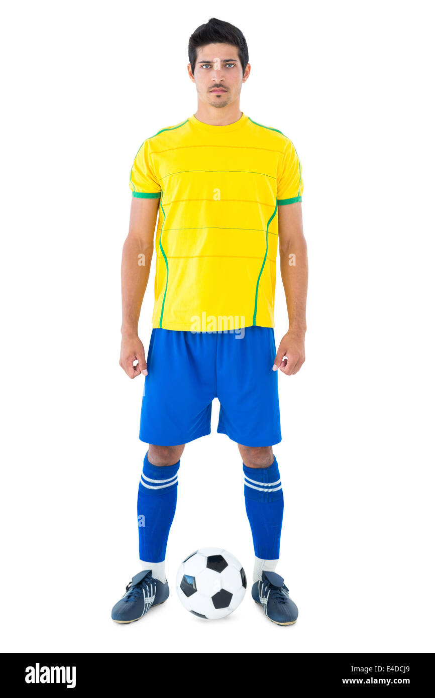 Football player in yellow with ball Stock Photo - Alamy