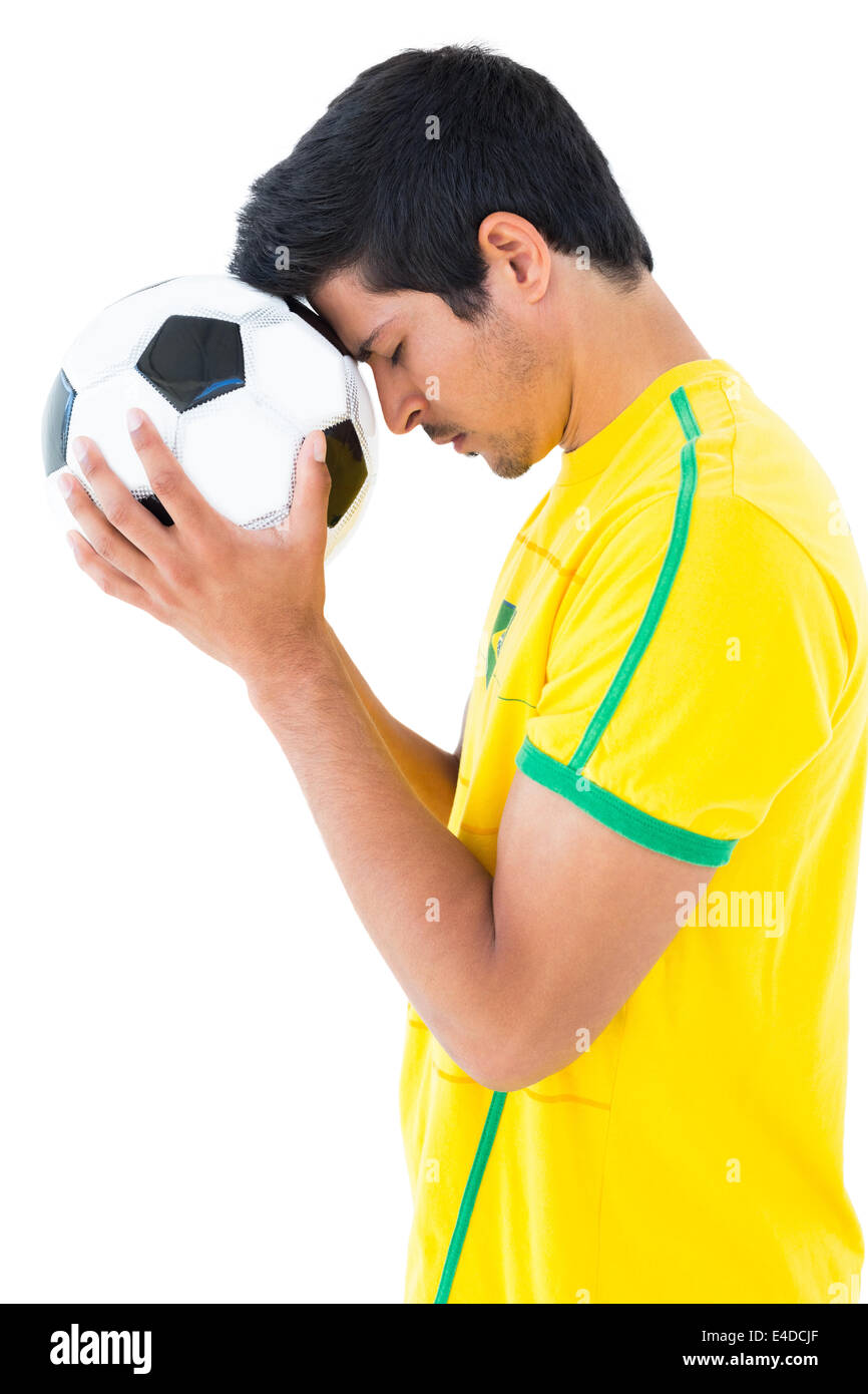 Football player in yellow with ball Stock Photo - Alamy