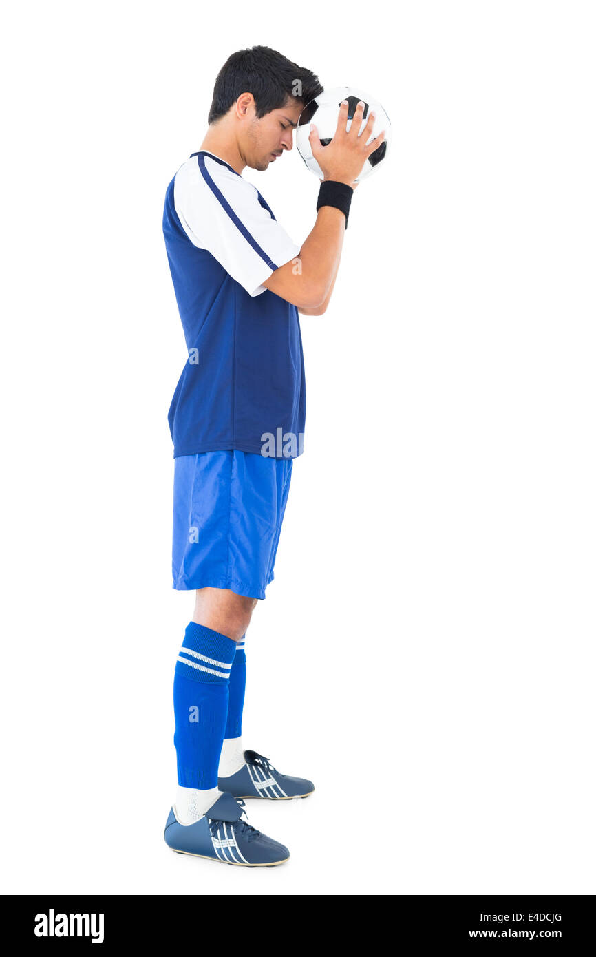 Football player in blue with ball Stock Photo - Alamy