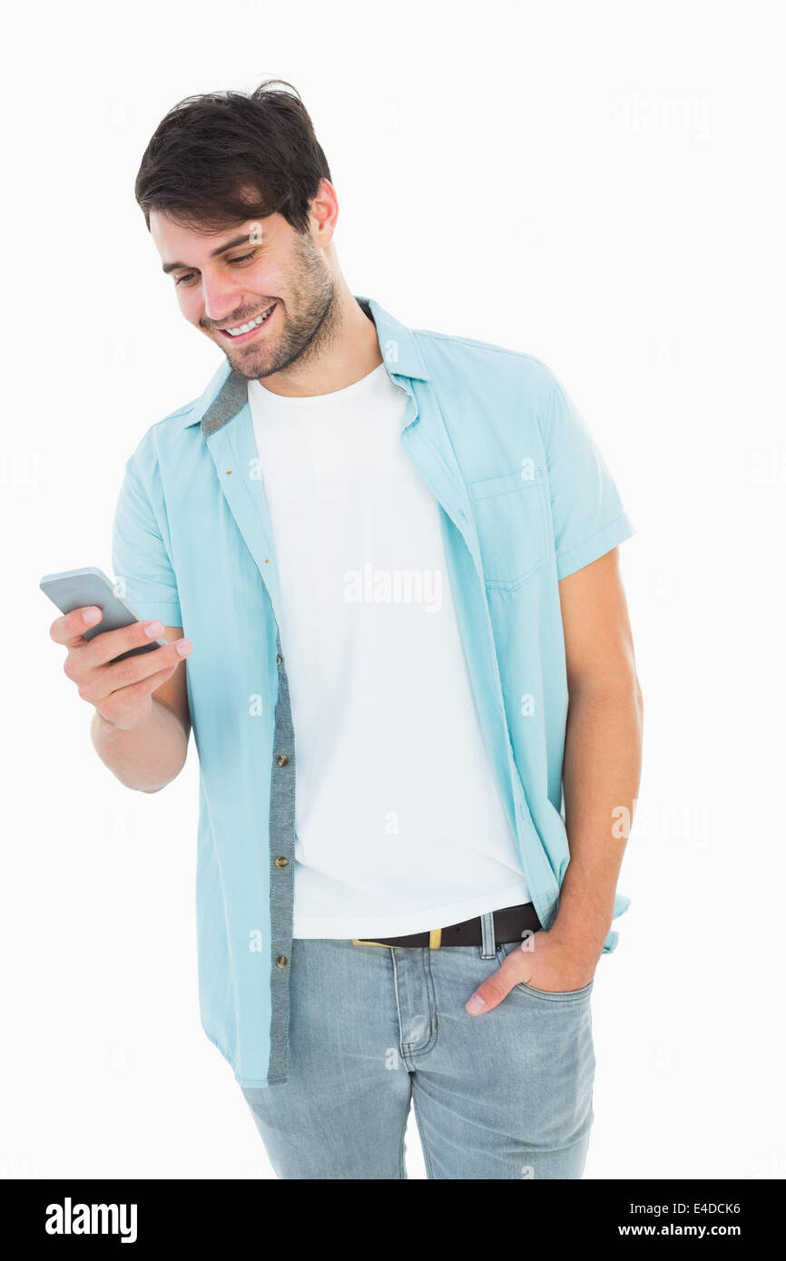 Happy casual man sending a text message Stock Photo - Alamy