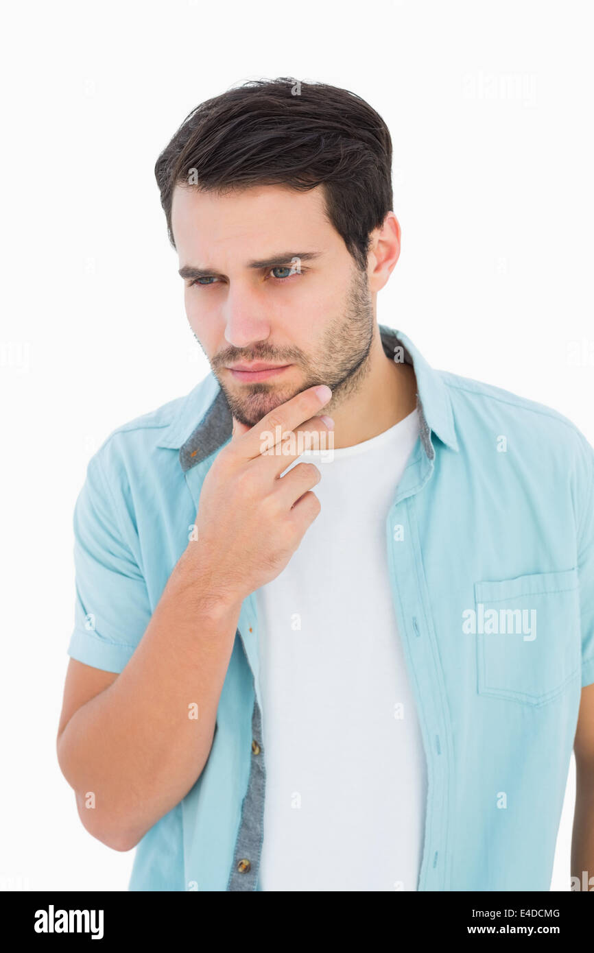 Happy casual man thinking with hand on chin Stock Photo - Alamy