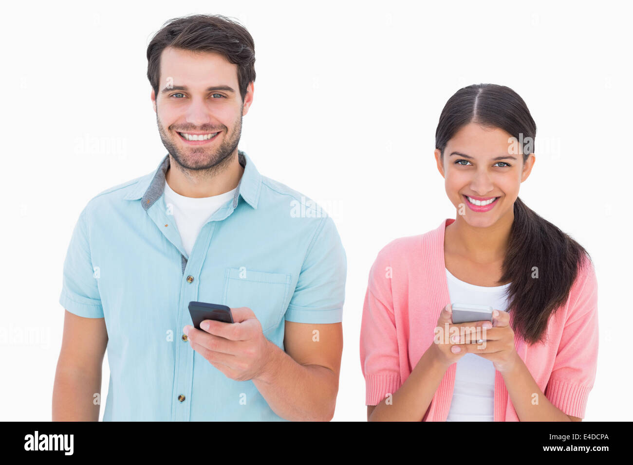 Happy couple sending text messages Stock Photo - Alamy