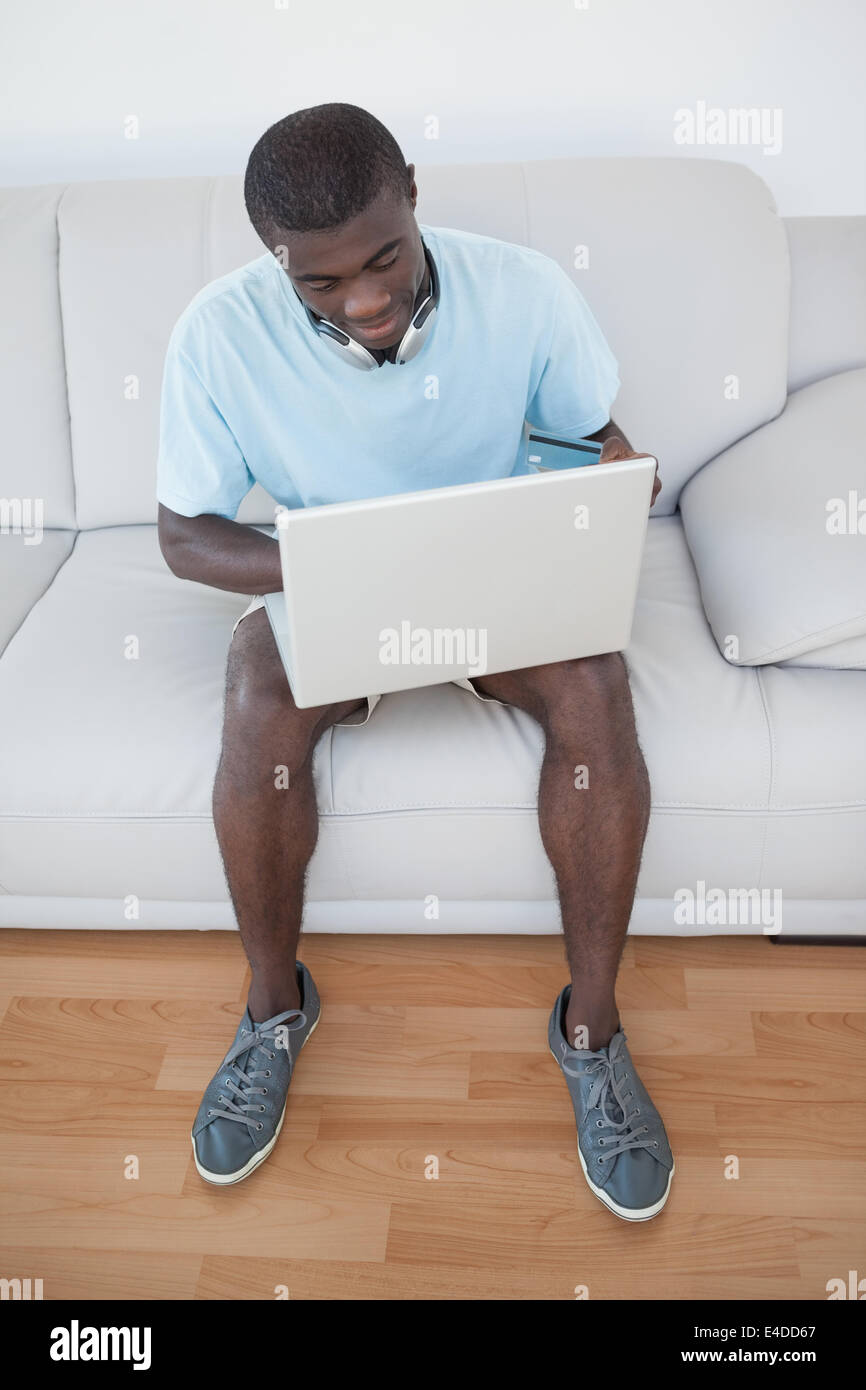 Man sitting on sofa browsing hi-res stock photography and images - Alamy