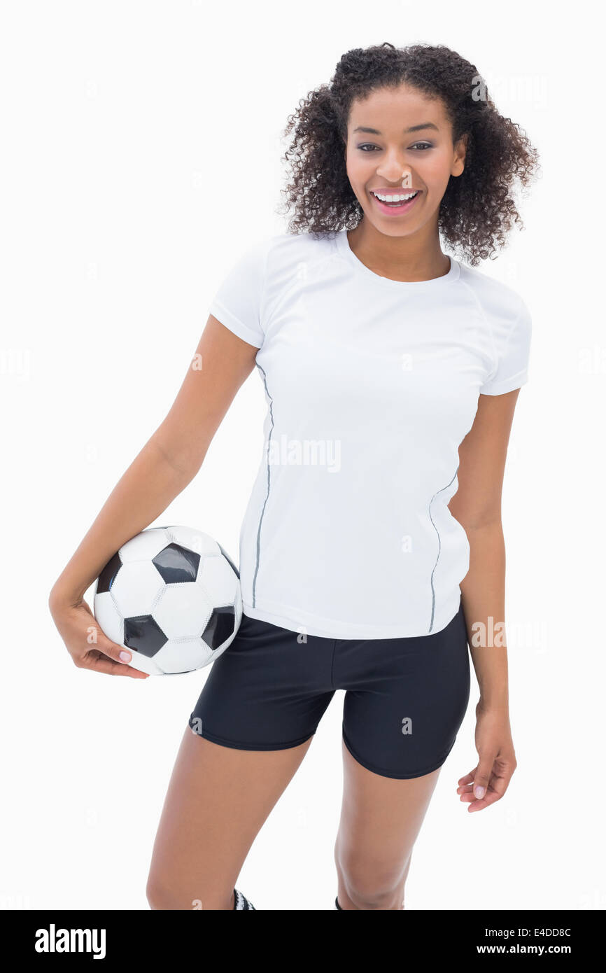 Pretty girl holding football and smiling at camera Stock Photo - Alamy