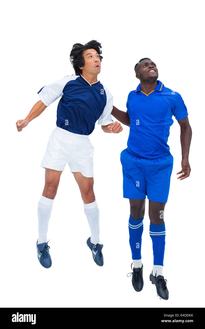 Football players tackling for the ball Stock Photo - Alamy