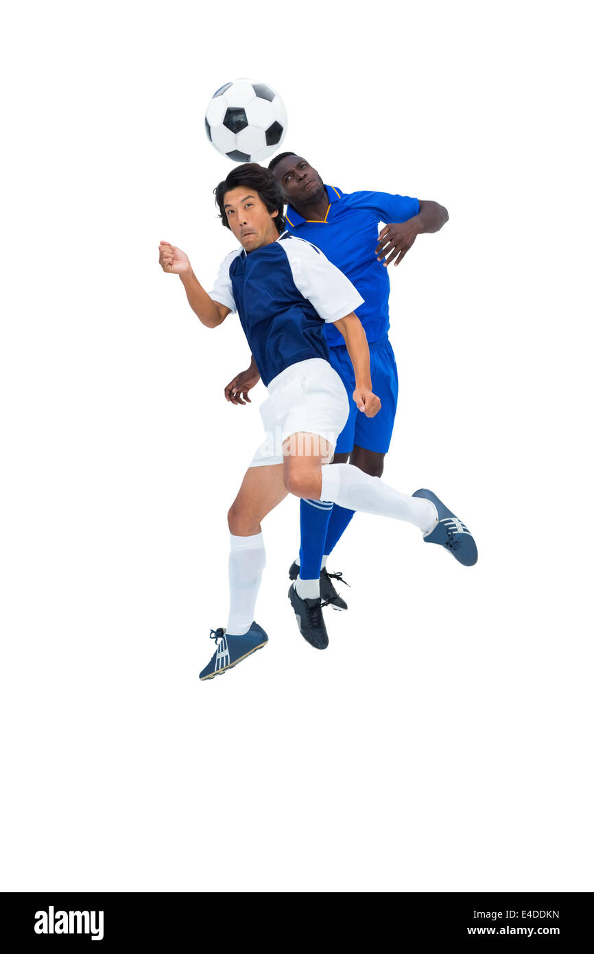 Football players tackling for the ball Stock Photo - Alamy