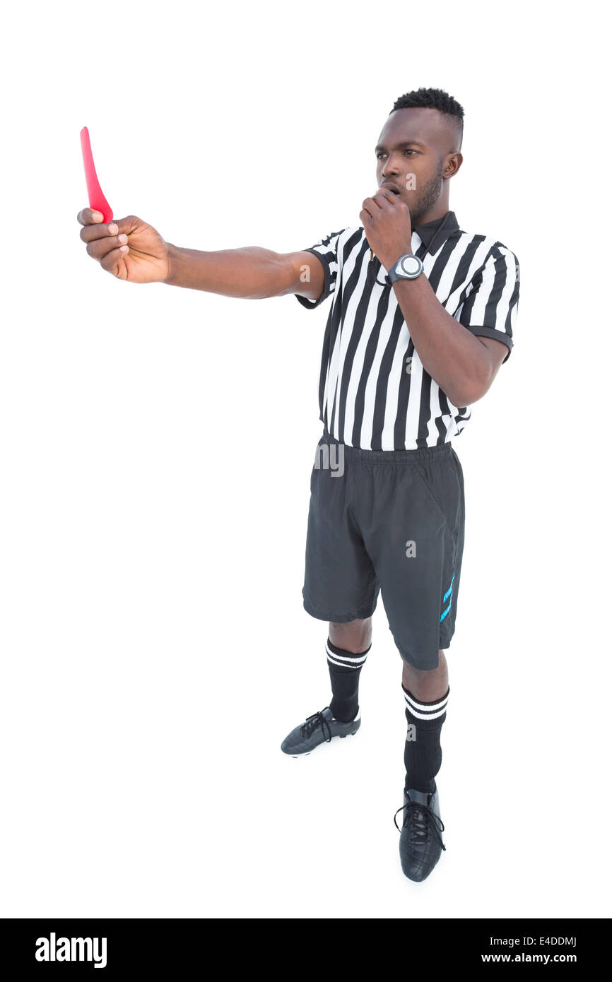 Serious referee showing red card blowing whistle Stock Photo - Alamy