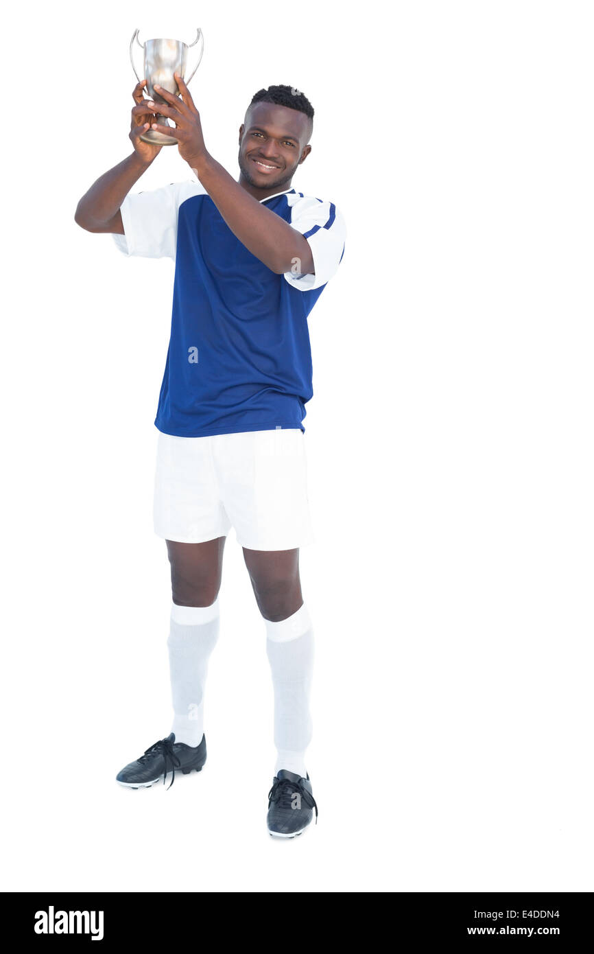 Happy football player holding winners cup Stock Photo - Alamy