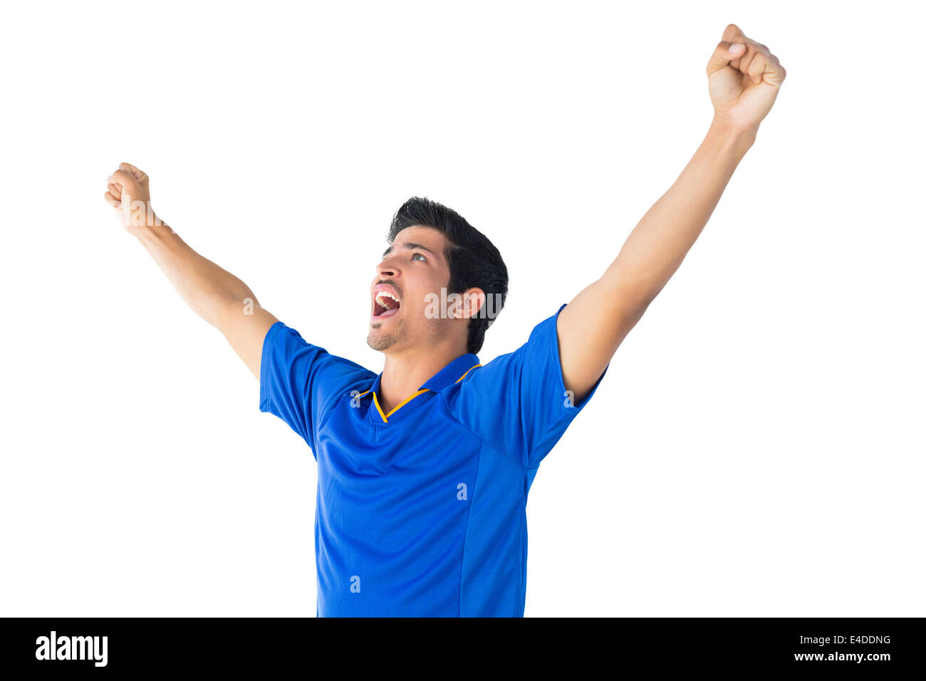 Happy football player in blue celebrating Stock Photo - Alamy