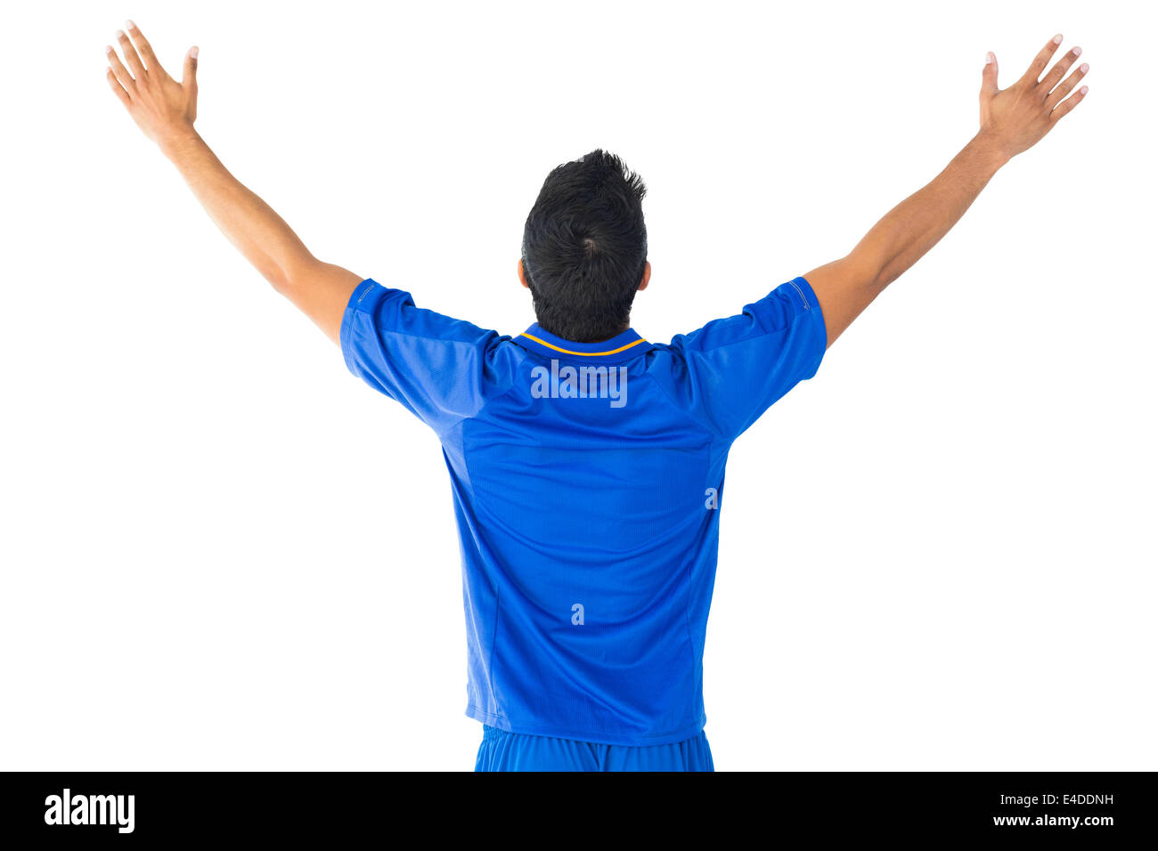 Happy football player in blue celebrating Stock Photo - Alamy