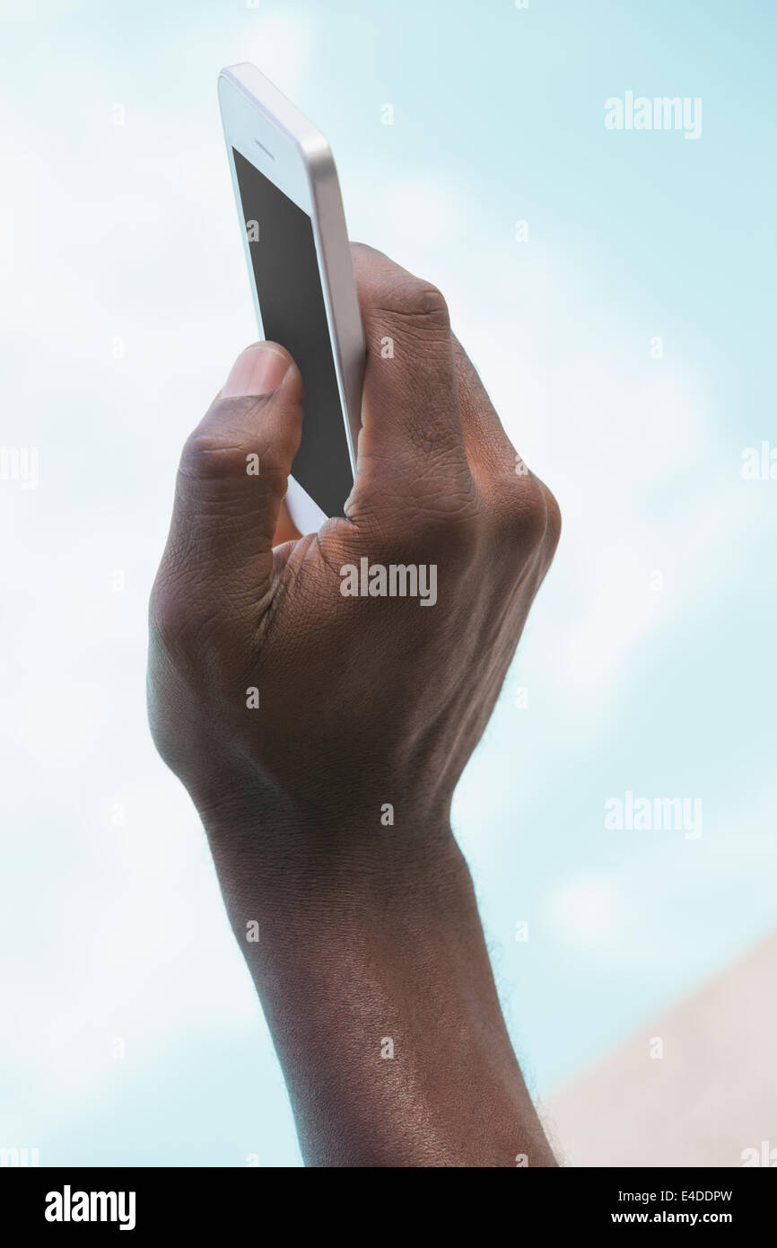 Man holding smartphone in hand Stock Photo - Alamy