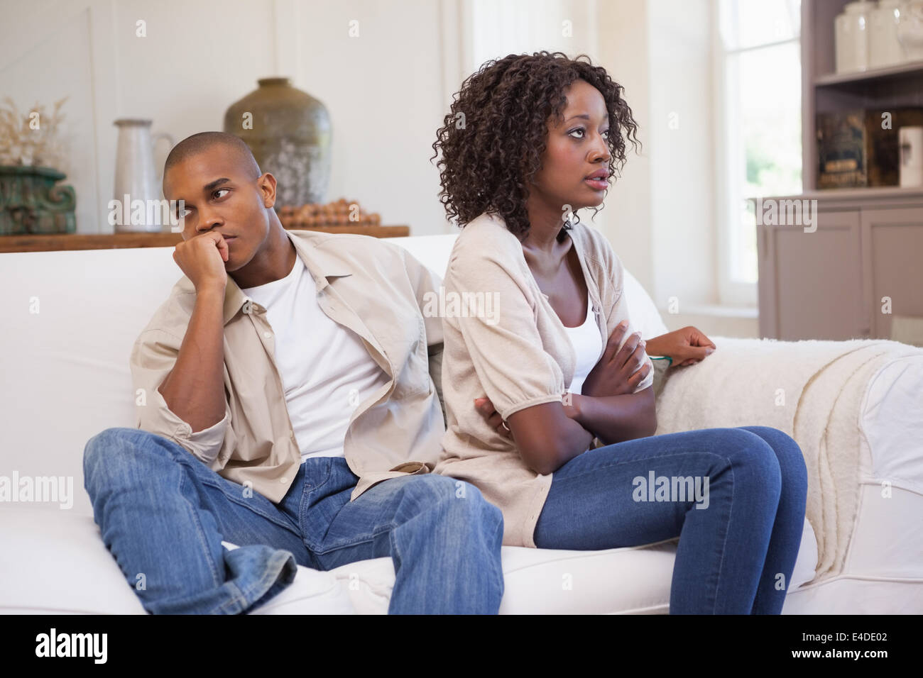 Unhappy couple arguing on the couch Stock Photo - Alamy