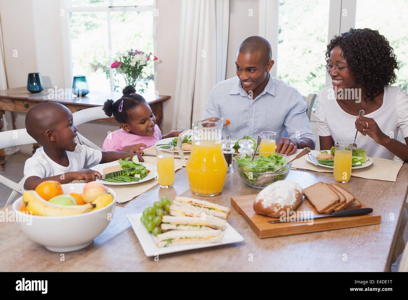 Happy family having lunch together Stock Photo - Alamy
