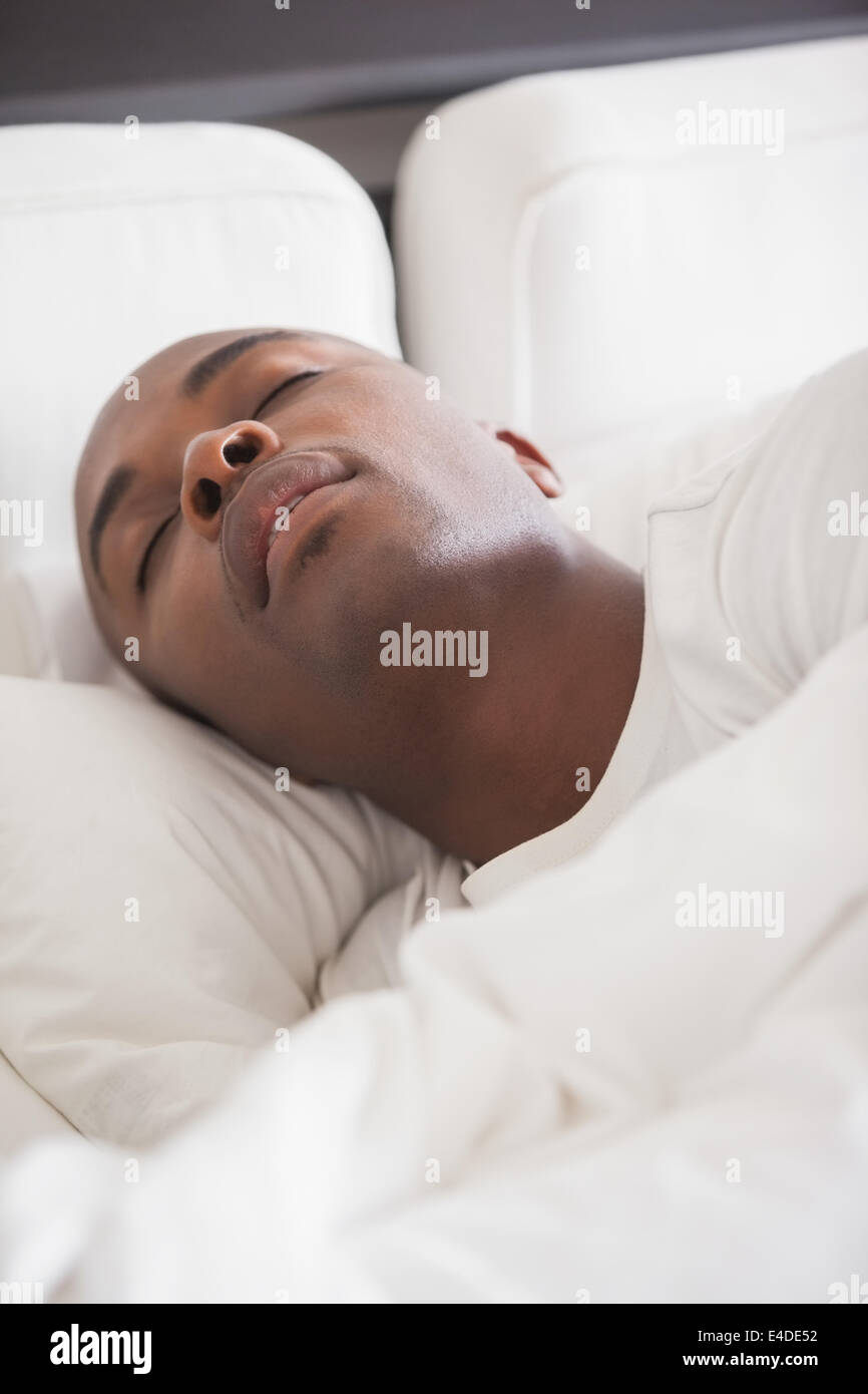 Peaceful man sleeping in bed Stock Photo - Alamy