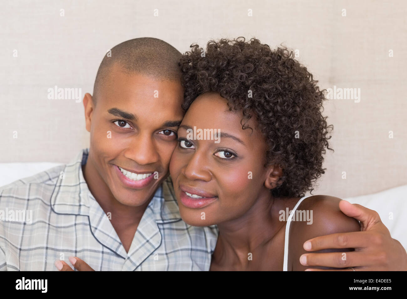 Happy couple cuddling sitting on hi-res stock photography and images ...