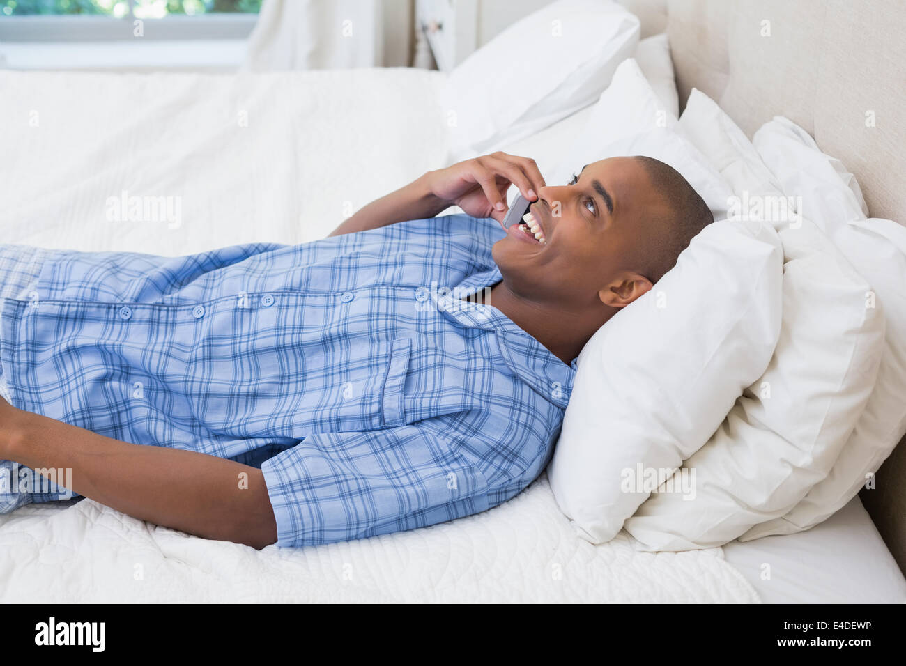 Man lying on bed holding hi-res stock photography and images - Alamy