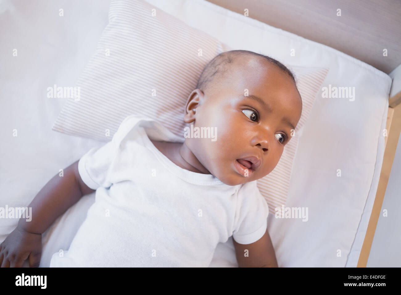 Adorable baby boy lying in his crib Stock Photo - Alamy
