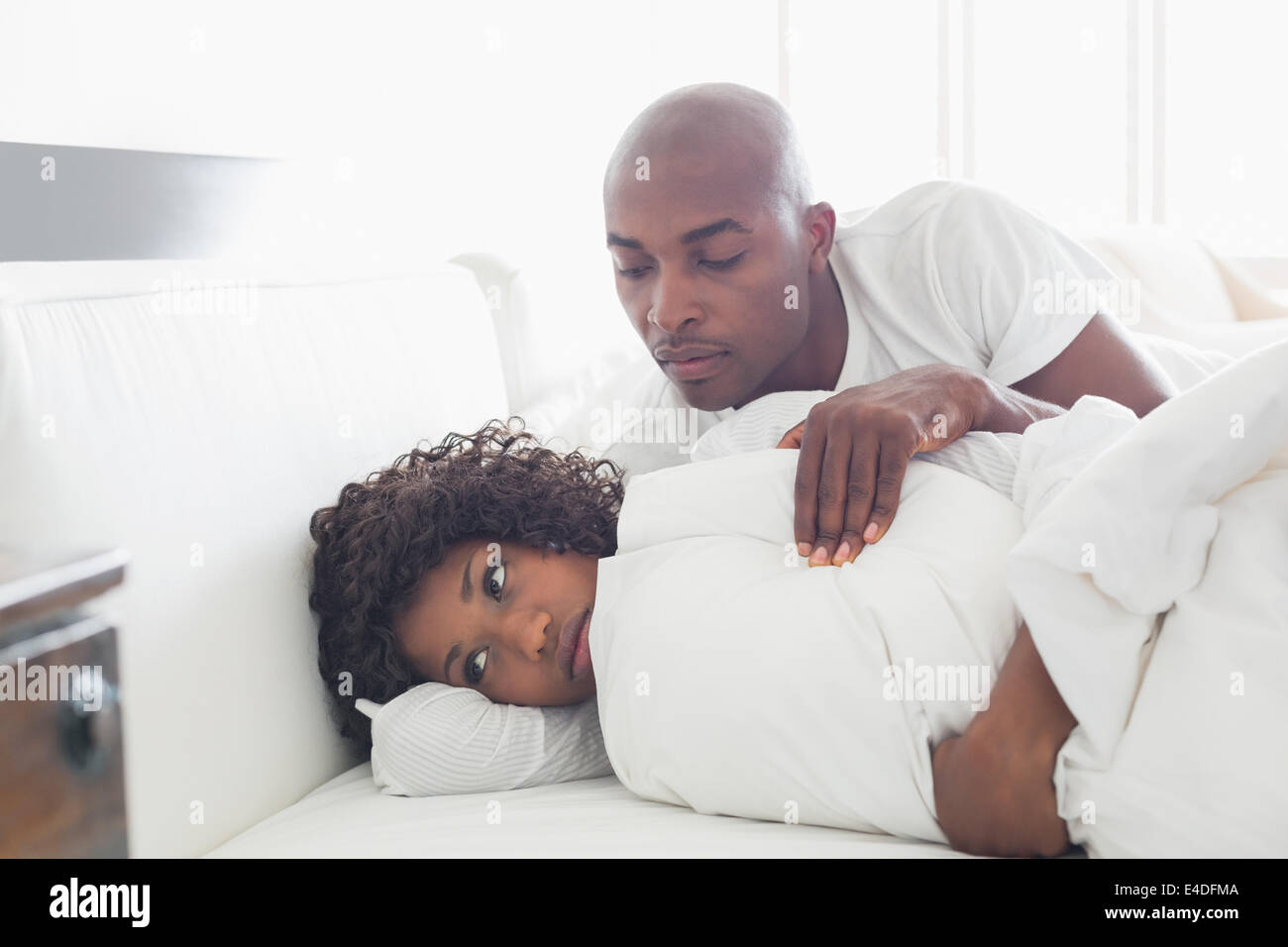 Young couple arguing in bed Stock Photo - Alamy