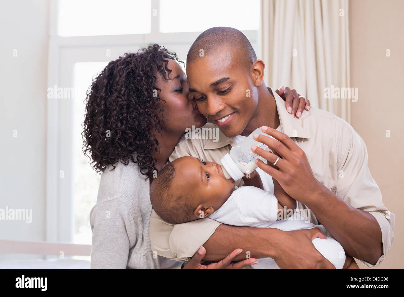 Parents kissing boy hi-res stock photography and images - Alamy