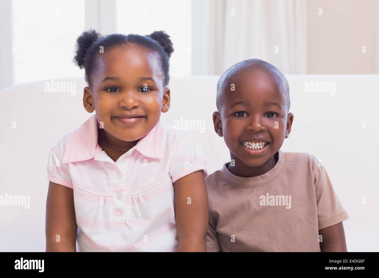 Happy siblings smiling at camera together Stock Photo - Alamy