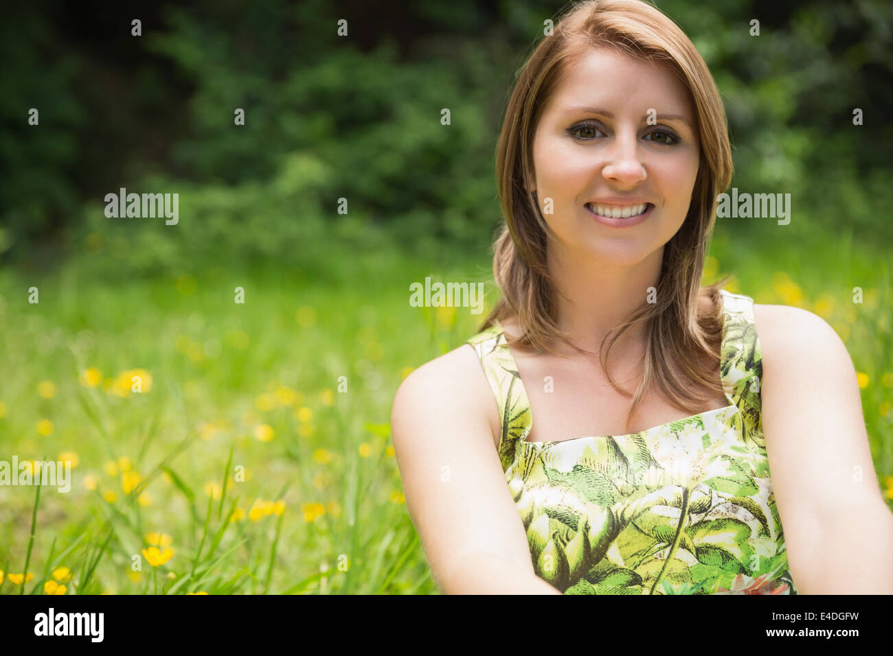 Cute young woman relaxing in field Stock Photo - Alamy