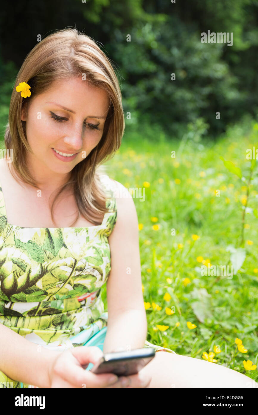 Woman text messaging in field Stock Photo - Alamy