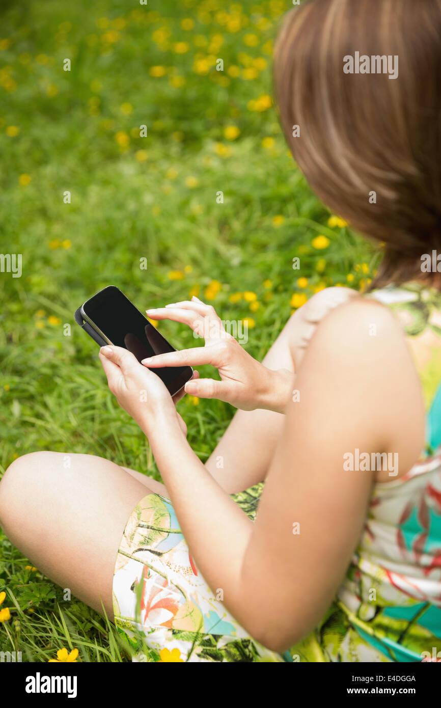 Woman text messaging in field Stock Photo - Alamy