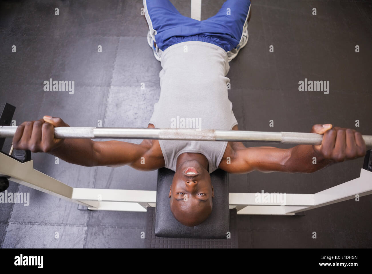 Muscular man lifting barbell in gym Stock Photo - Alamy
