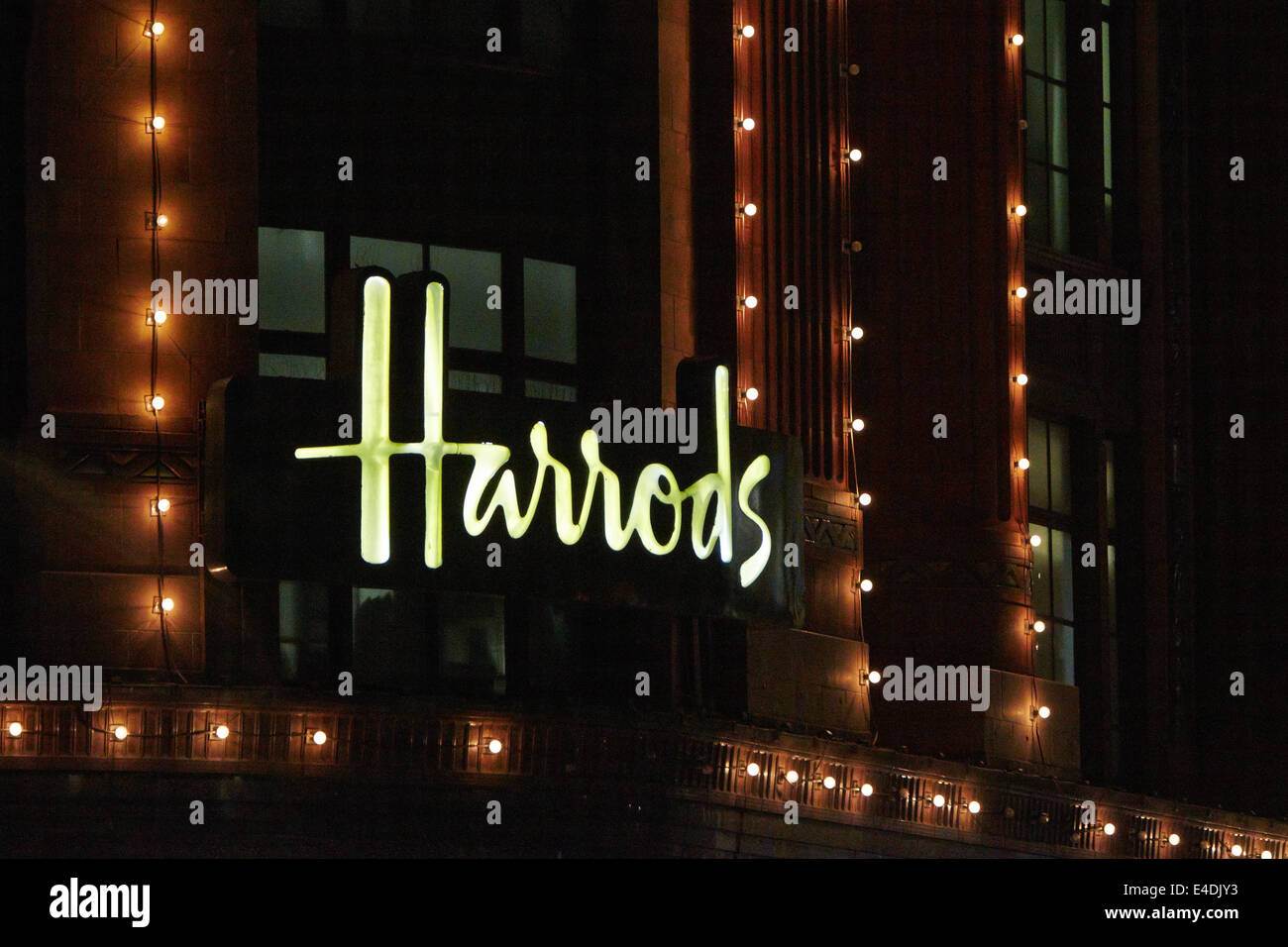 General view of an illuminated Harrods sign at night Stock Photo - Alamy