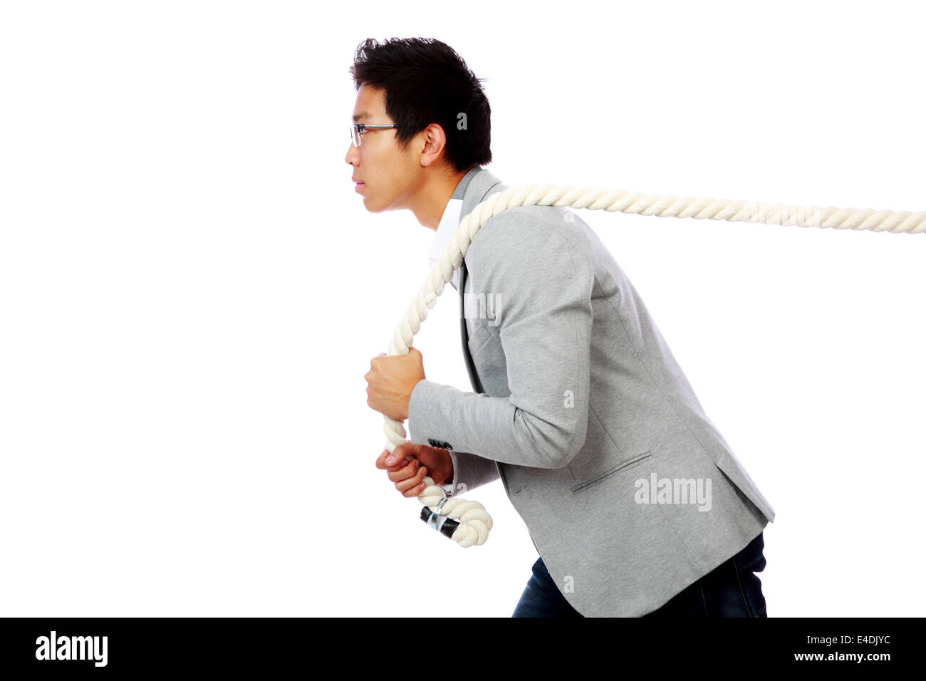 Portrait of a man pulling rope over white background Stock Photo - Alamy