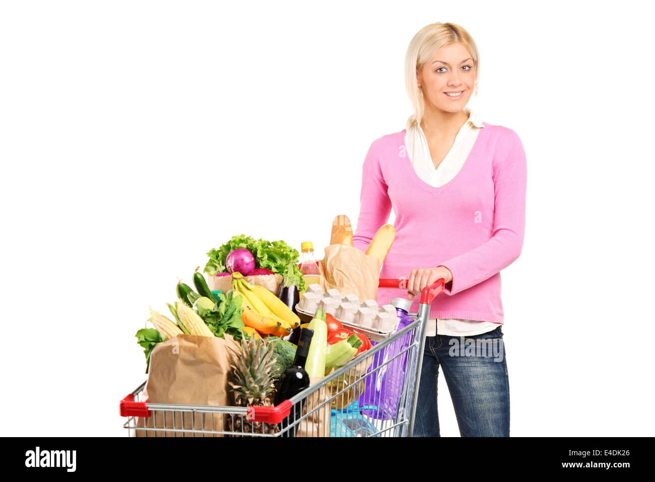 Woman pushing a shopping cart full of groceries Stock Photo - Alamy