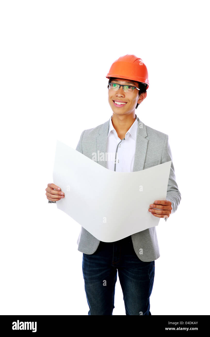 Portrait of a cheerful asian engineer holding blueprint over white ...