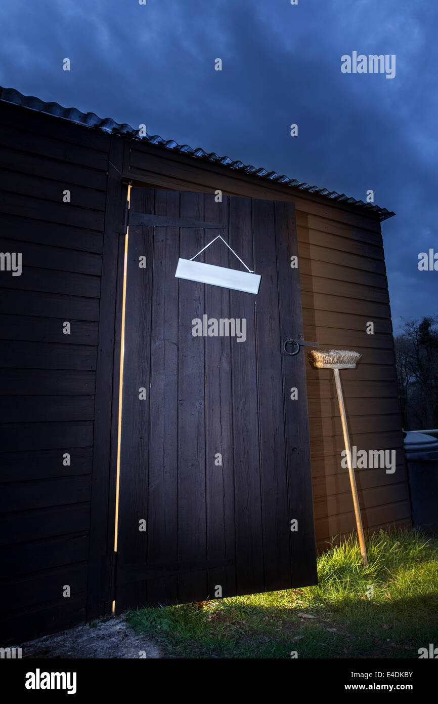 Light spilling from an open workshop door Stock Photo - Alamy