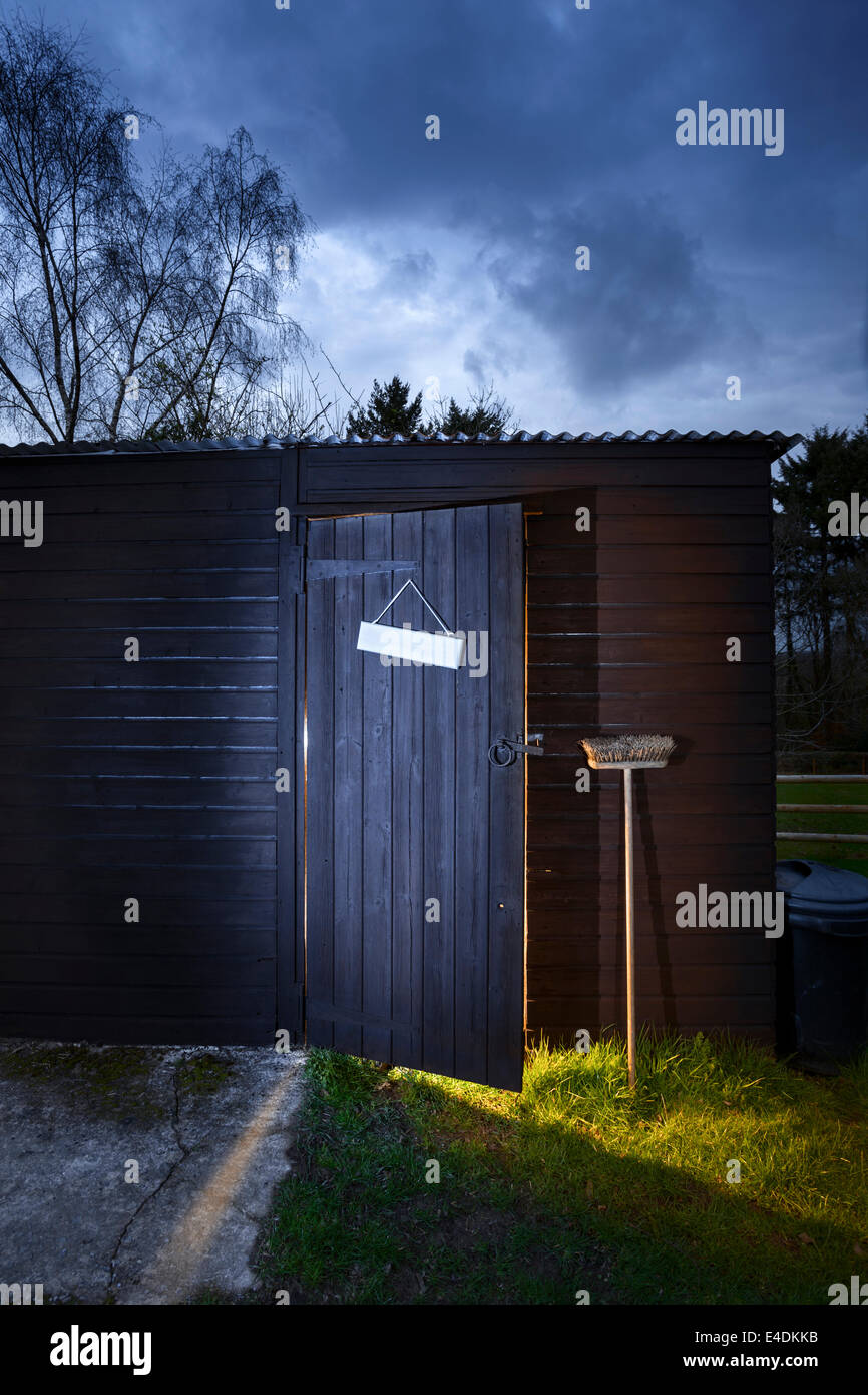 Light spilling from an open workshop door Stock Photo - Alamy