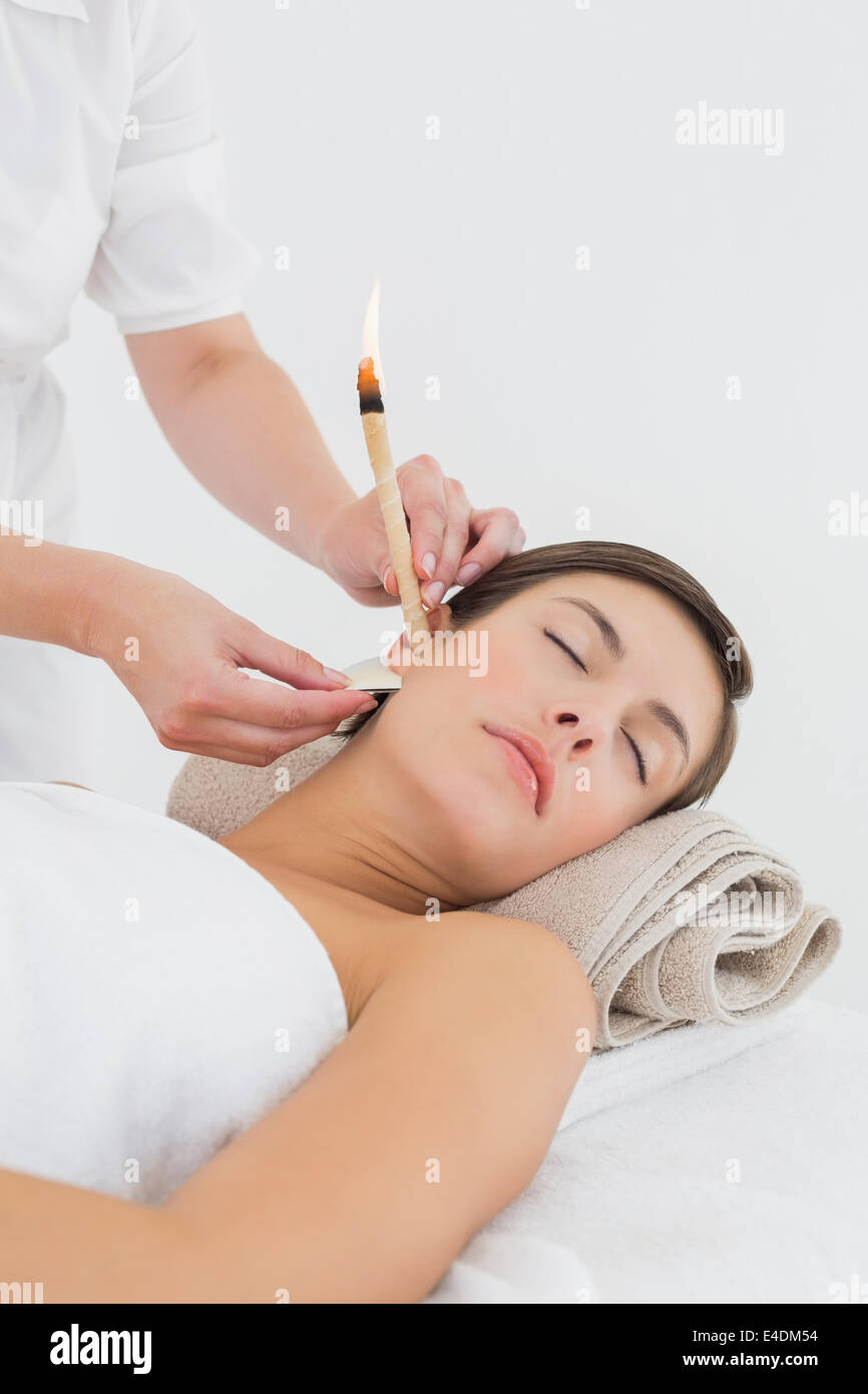 Beautiful Woman Receiving Ear Candle Treatment At Spa Center Stock