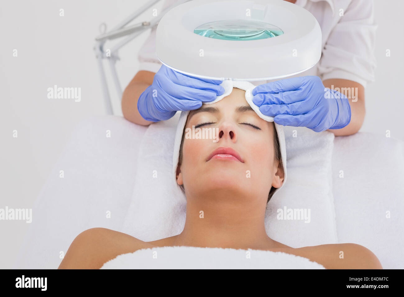 Hands cleaning woman's face with cotton swabs Stock Photo - Alamy