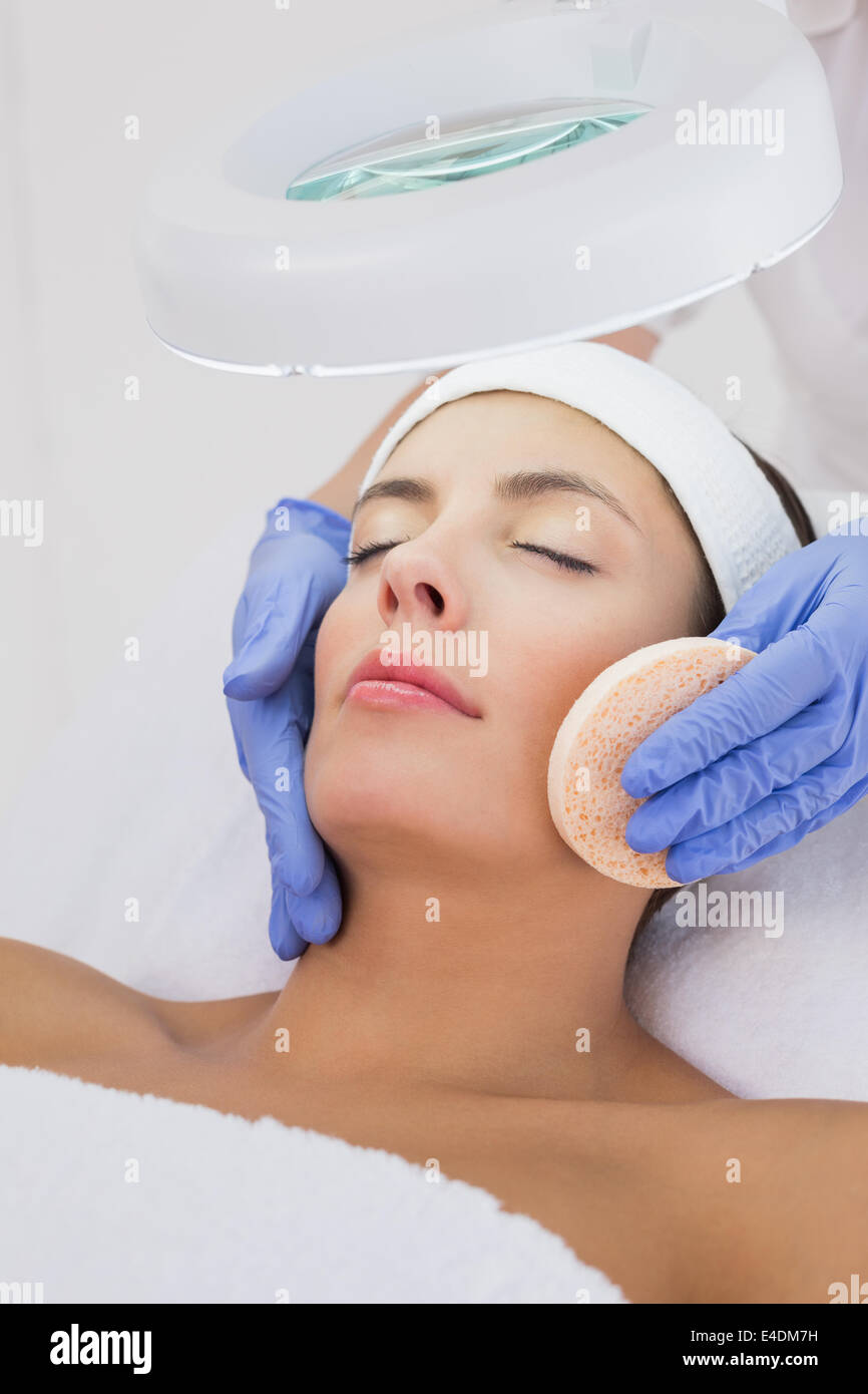 Hands cleaning woman's face with cotton swab Stock Photo - Alamy
